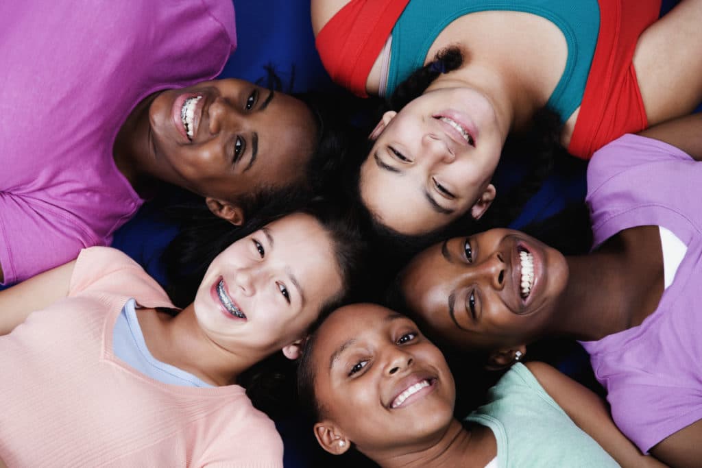 girls laying in a circle - Binda Consulting International